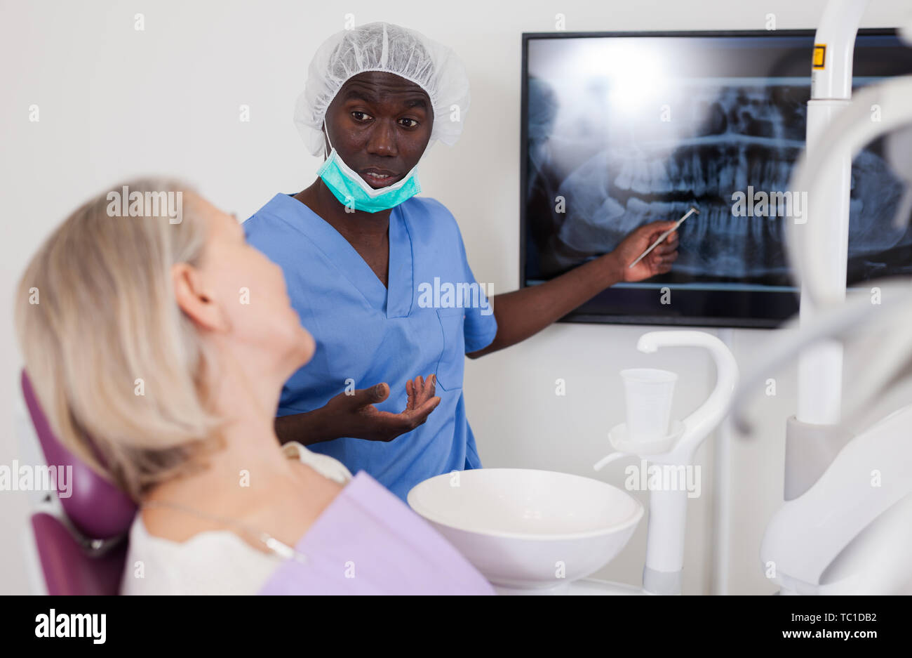 African american doctor man shows the patient an x-ray Stock Photo - Alamy