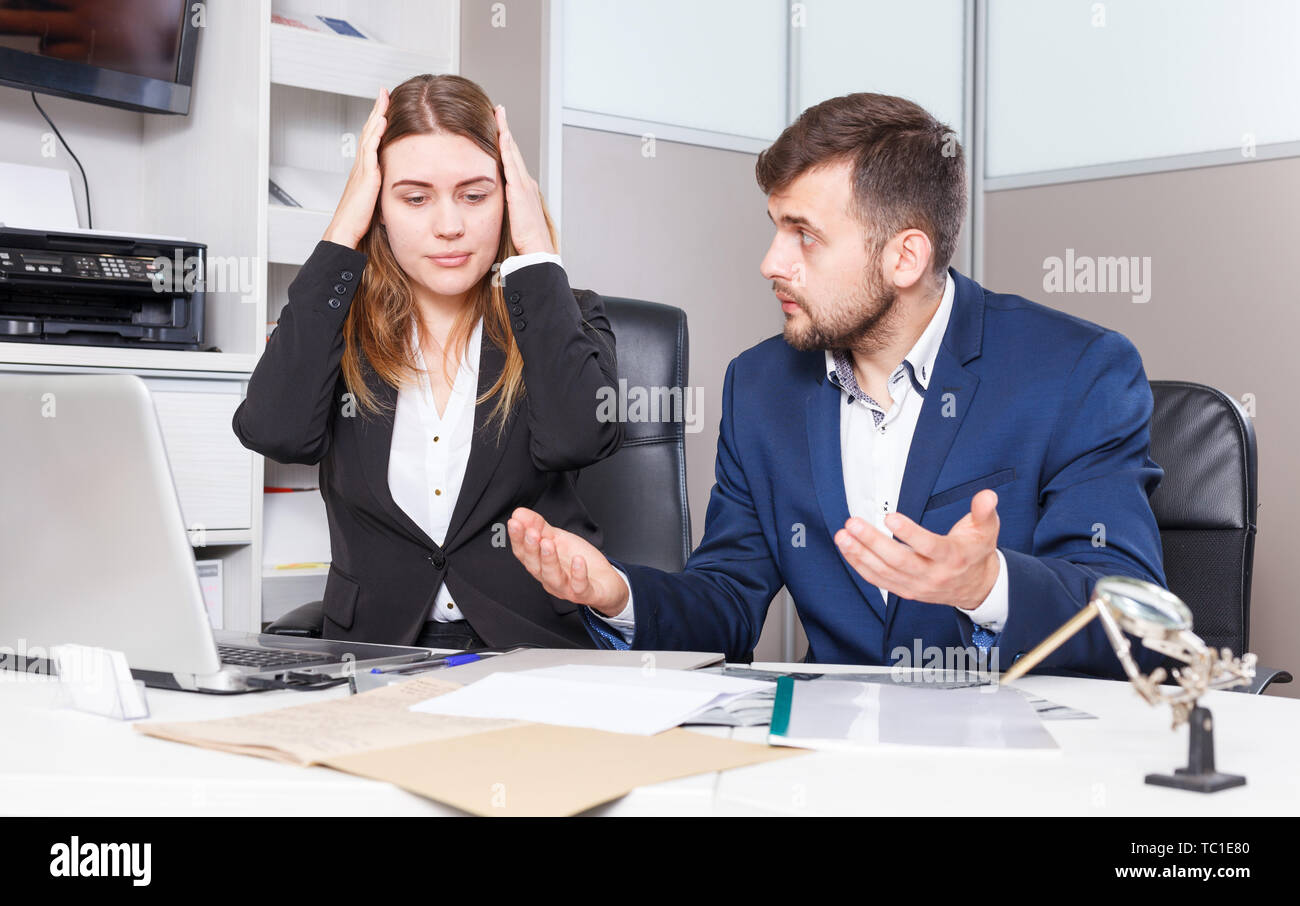 Frustrated female and male sales managers working in showroom, looking ...