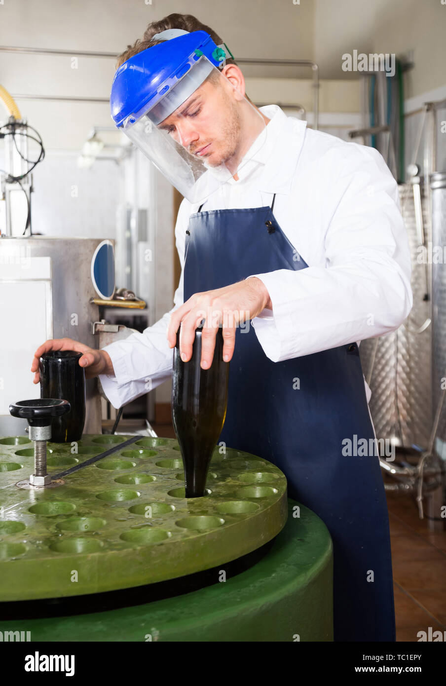 positive american adult male employee operating machine at sparkling ...