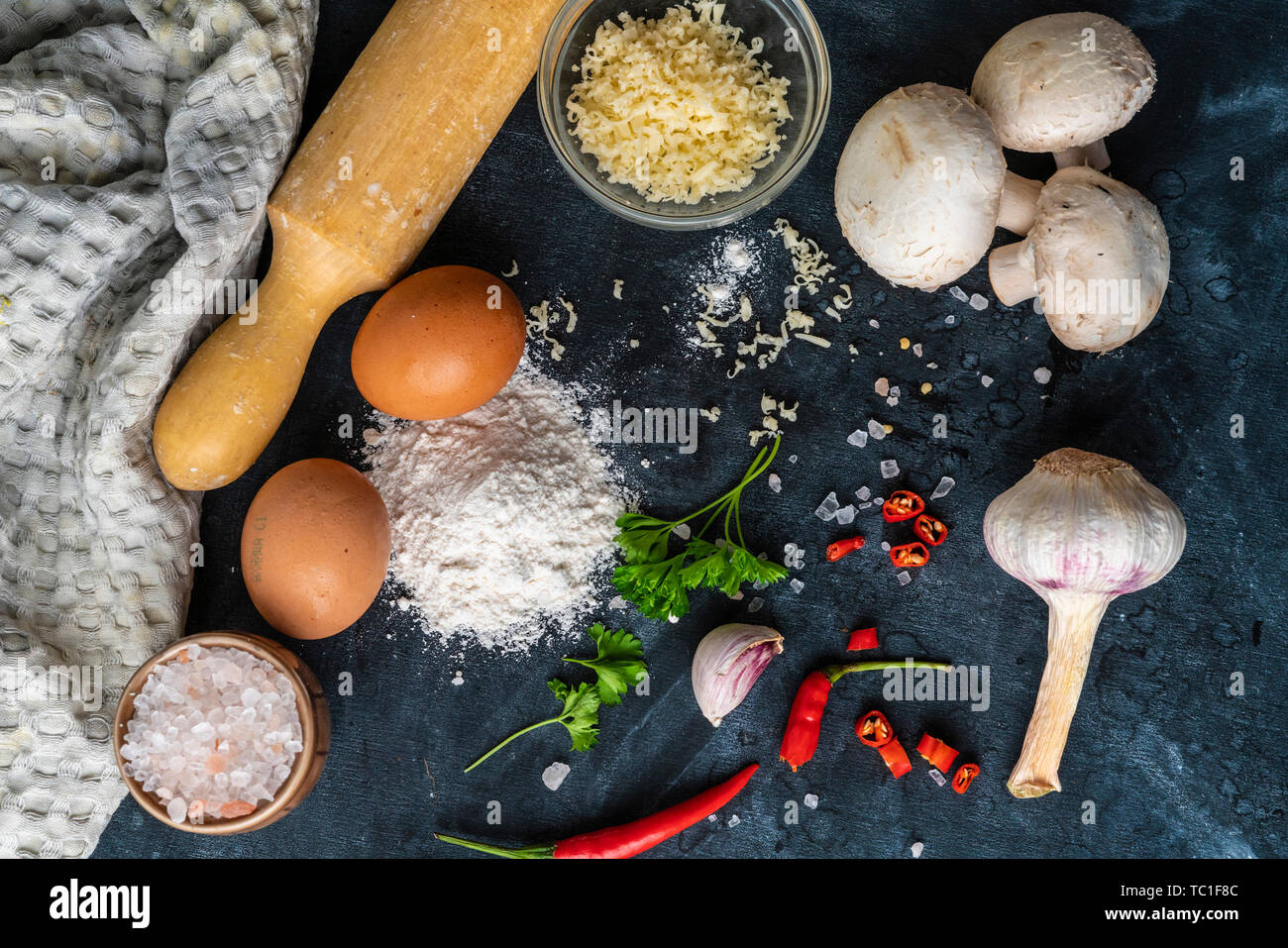raw ingredients for cooking on the table, cheese, salt, pepper, egg and ...
