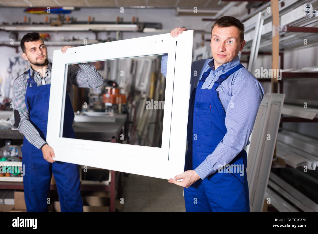 Workmen are holding the window frame together in workshop Stock Photo ...