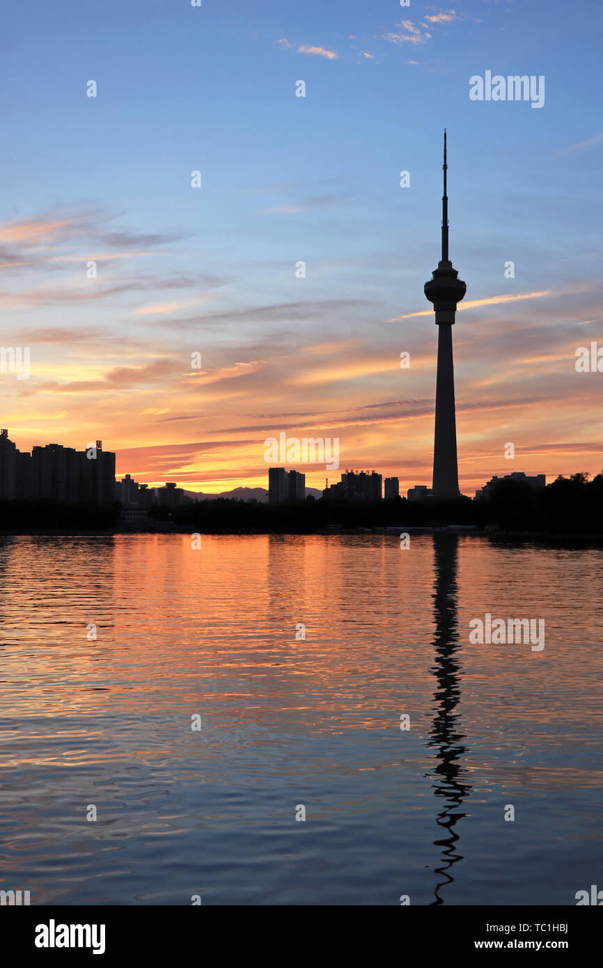 The CCTV tower at sunset, used as a cell phone lock screen Stock Photo ...
