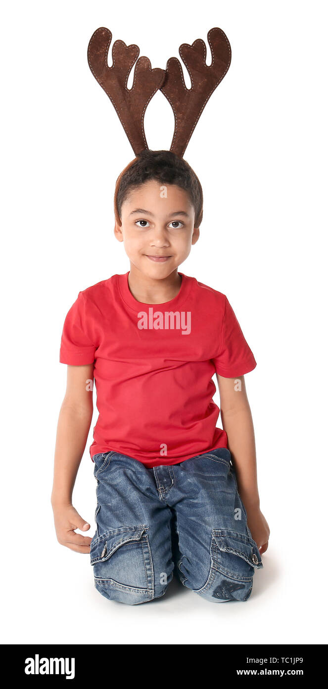 Portrait of cute little boy with deer horns on white background Stock ...