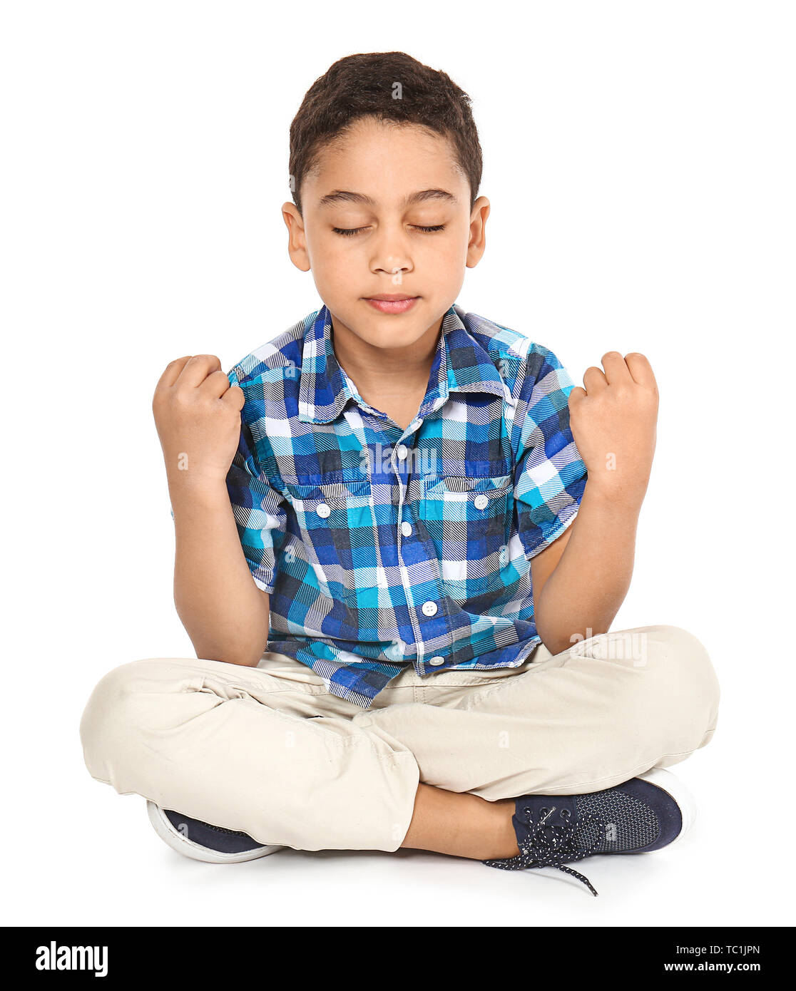 Portrait of cute meditating boy on white background Stock Photo - Alamy