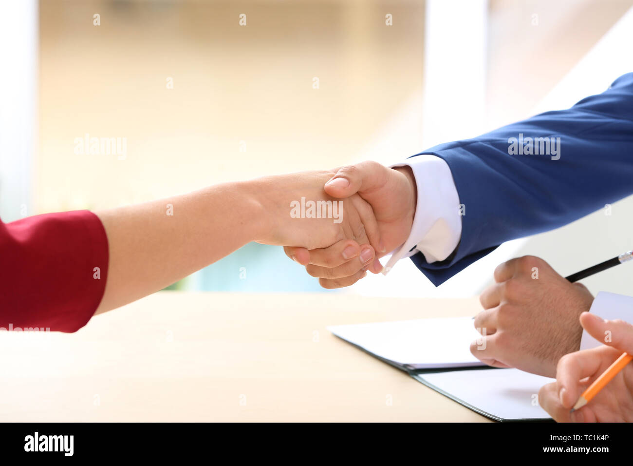 Human resources manager shaking hands with applicant after successful ...