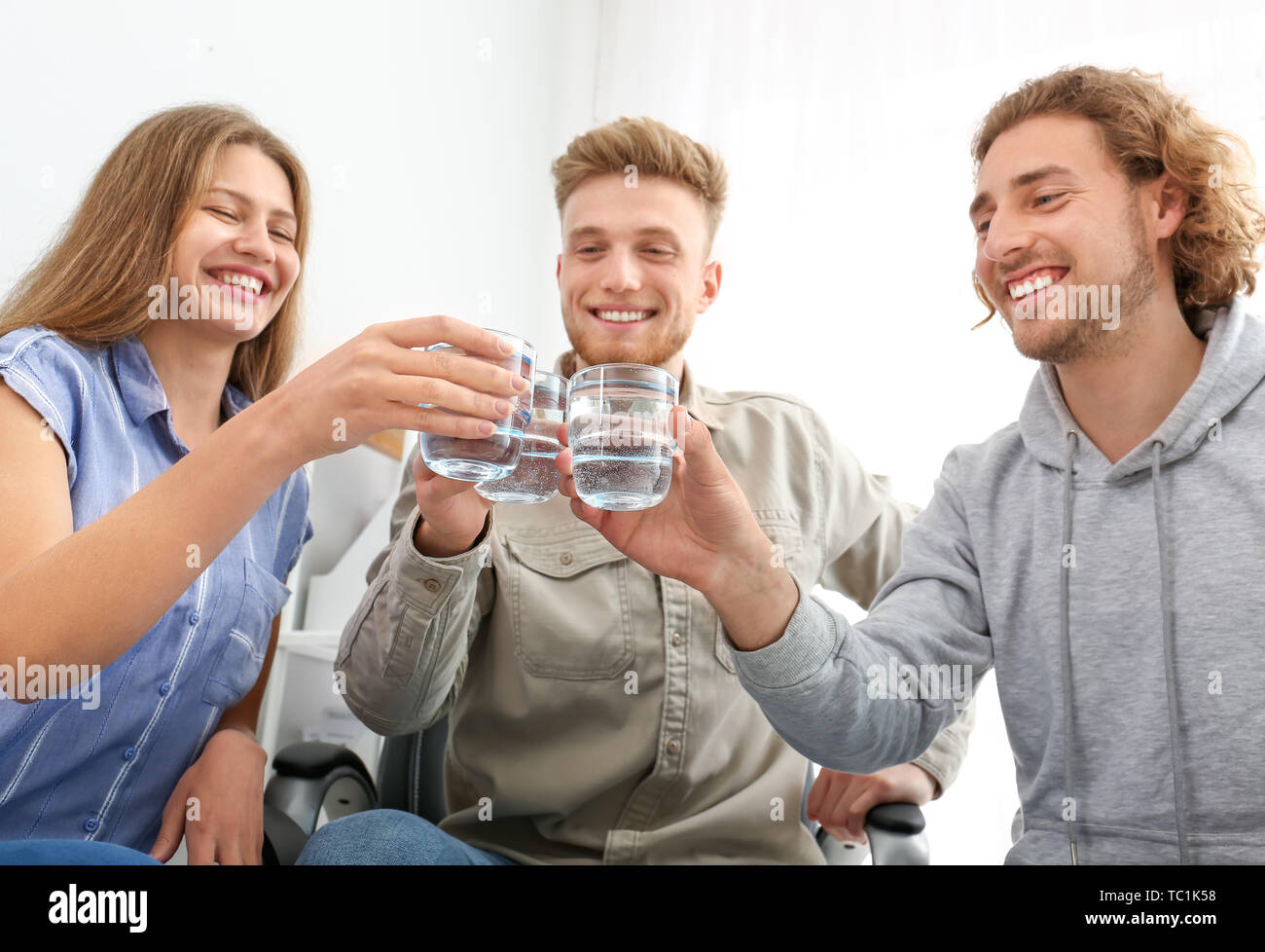 Group of people drinking water indoors Stock Photo - Alamy