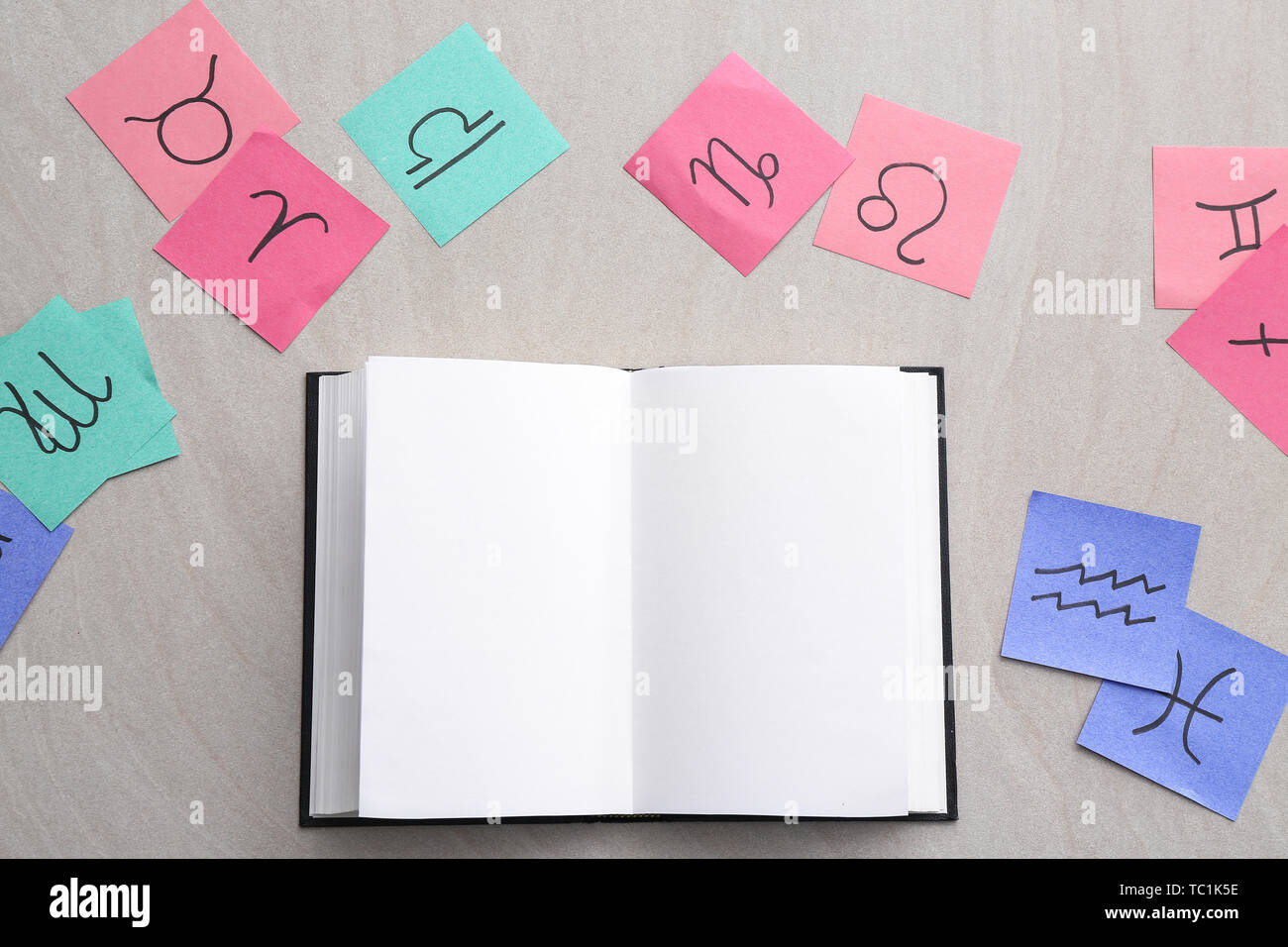 Open book with zodiac signs on grey background Stock Photo - Alamy
