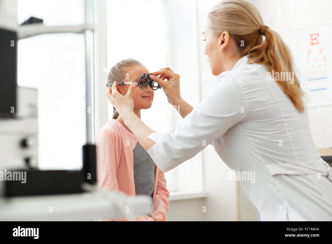 Doctor setting device. Positive good-looking child getting ready for ...