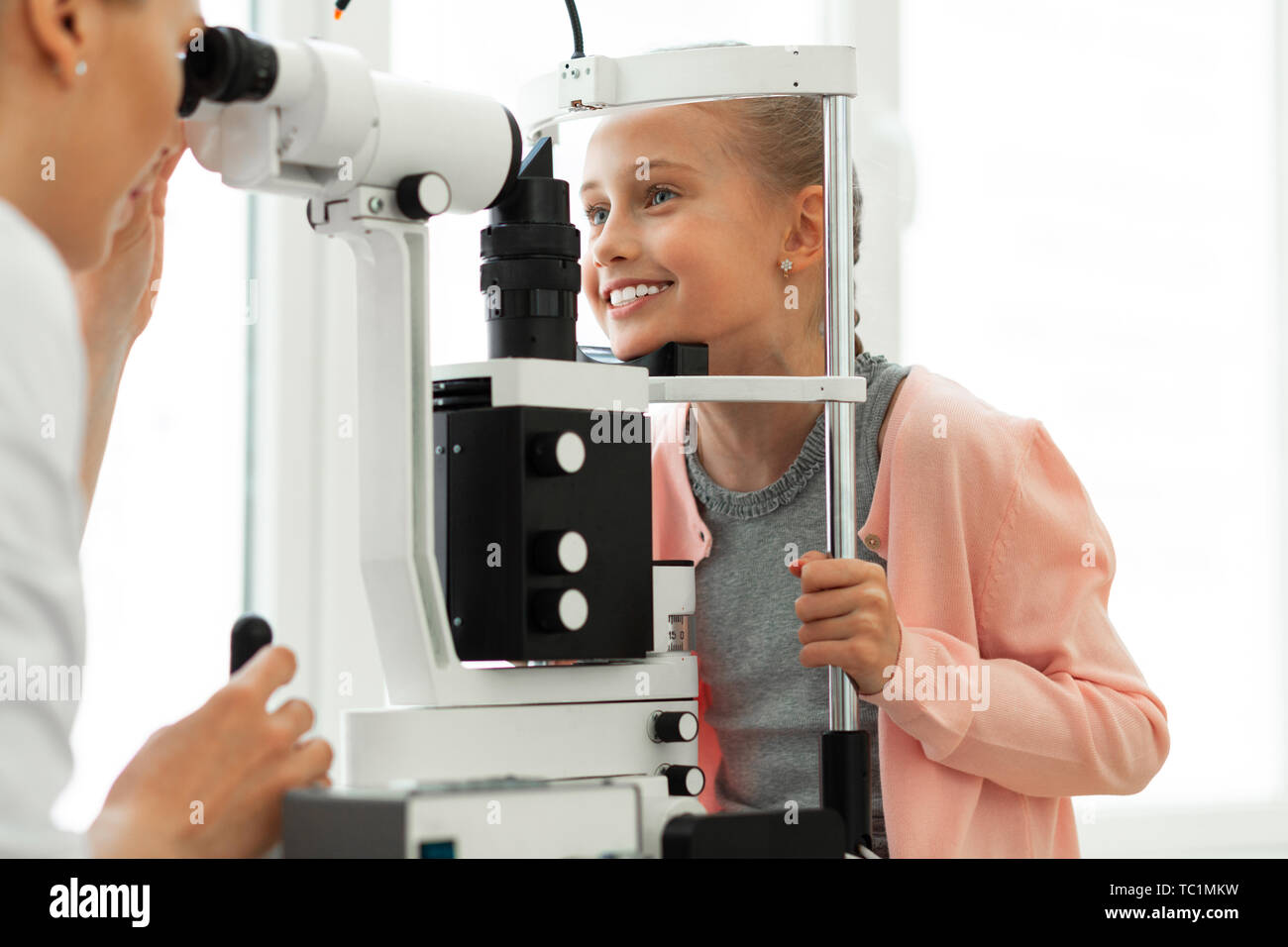 Doctor observing state. Cute young patient with blue eyes calmly ...