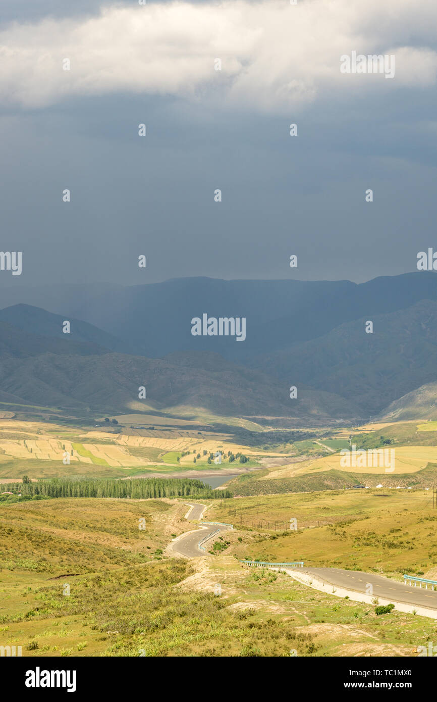 Hillside prairie villages under cloudy clouds Stock Photo - Alamy