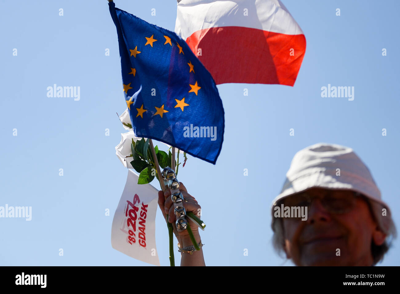 Spectator holds flags and flowers at the Solidarity Square during ...