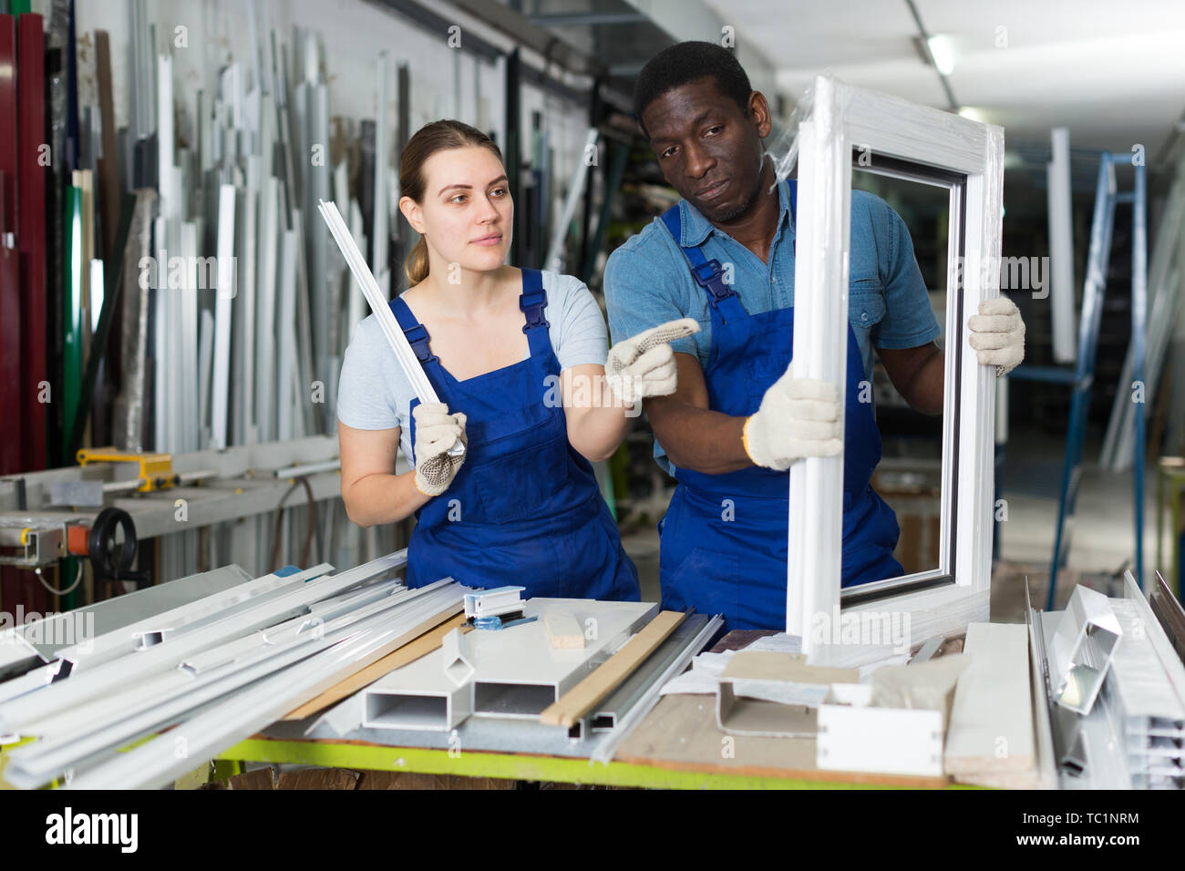 Two masters are working with window frame in the window workshop Stock ...