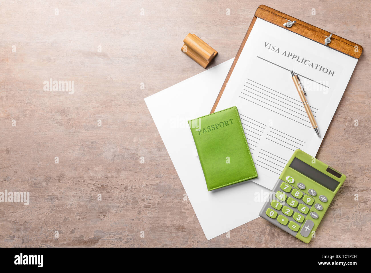 Visa application form, passport, stamp and calculator on table. Concept ...