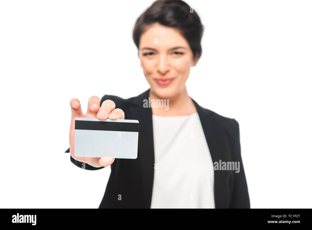 selective focus of smiling mixed race businesswoman showing credit card ...