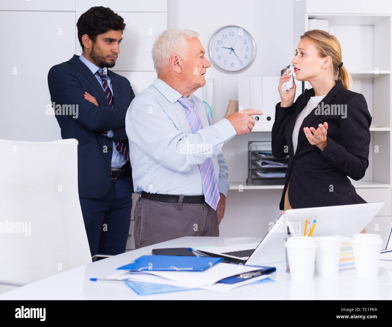 Mature businessman is chastising employees because of uncompleted work ...