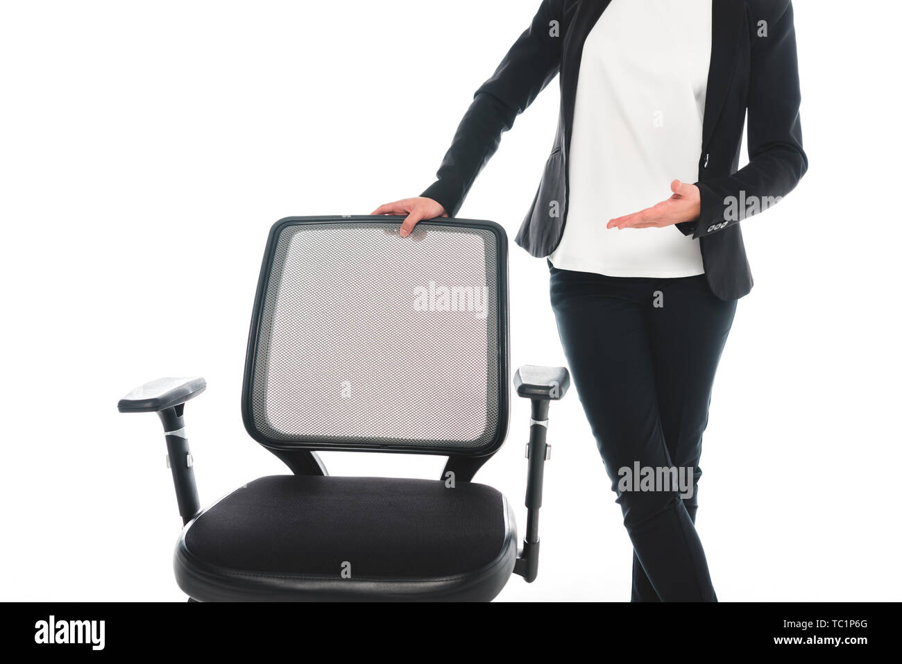 cropped view of businesswoman pointing with hand at office chair ...