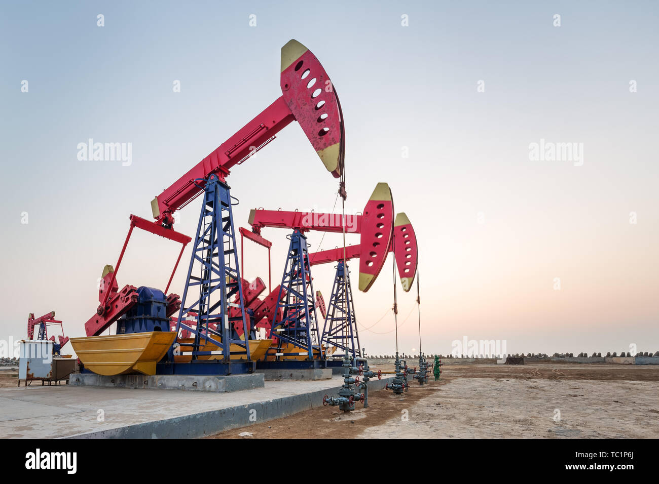 working oil-rig of oilfield day and night Stock Photo - Alamy