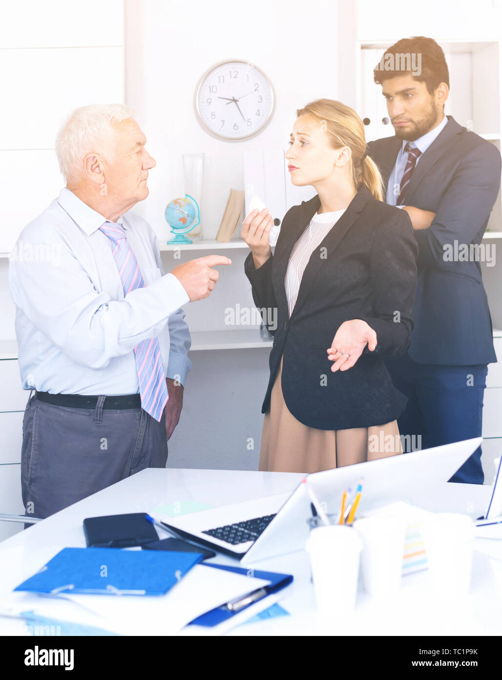 Mature boss is chastising employees because of uncompleted work in the office Stock Photo - Alamy