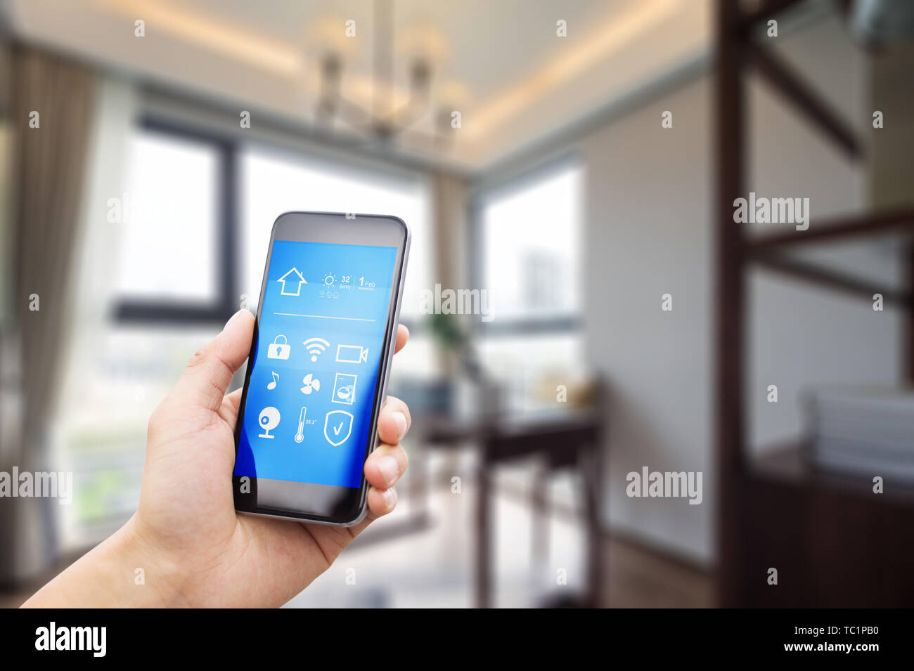 Mobile phone in smart home Stock Photo - Alamy
