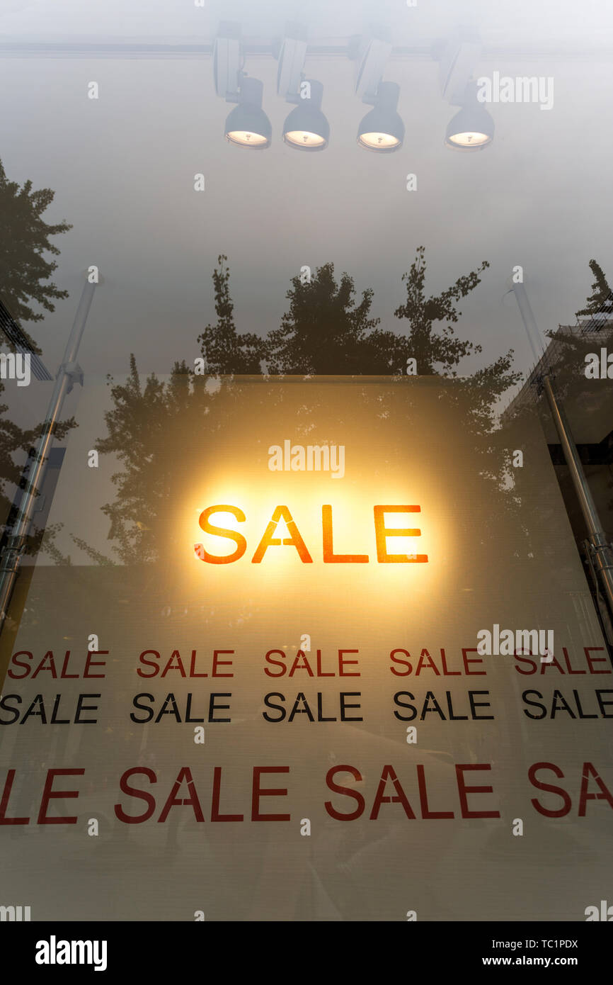 sale poster in the displaywindow of shop Stock Photo - Alamy