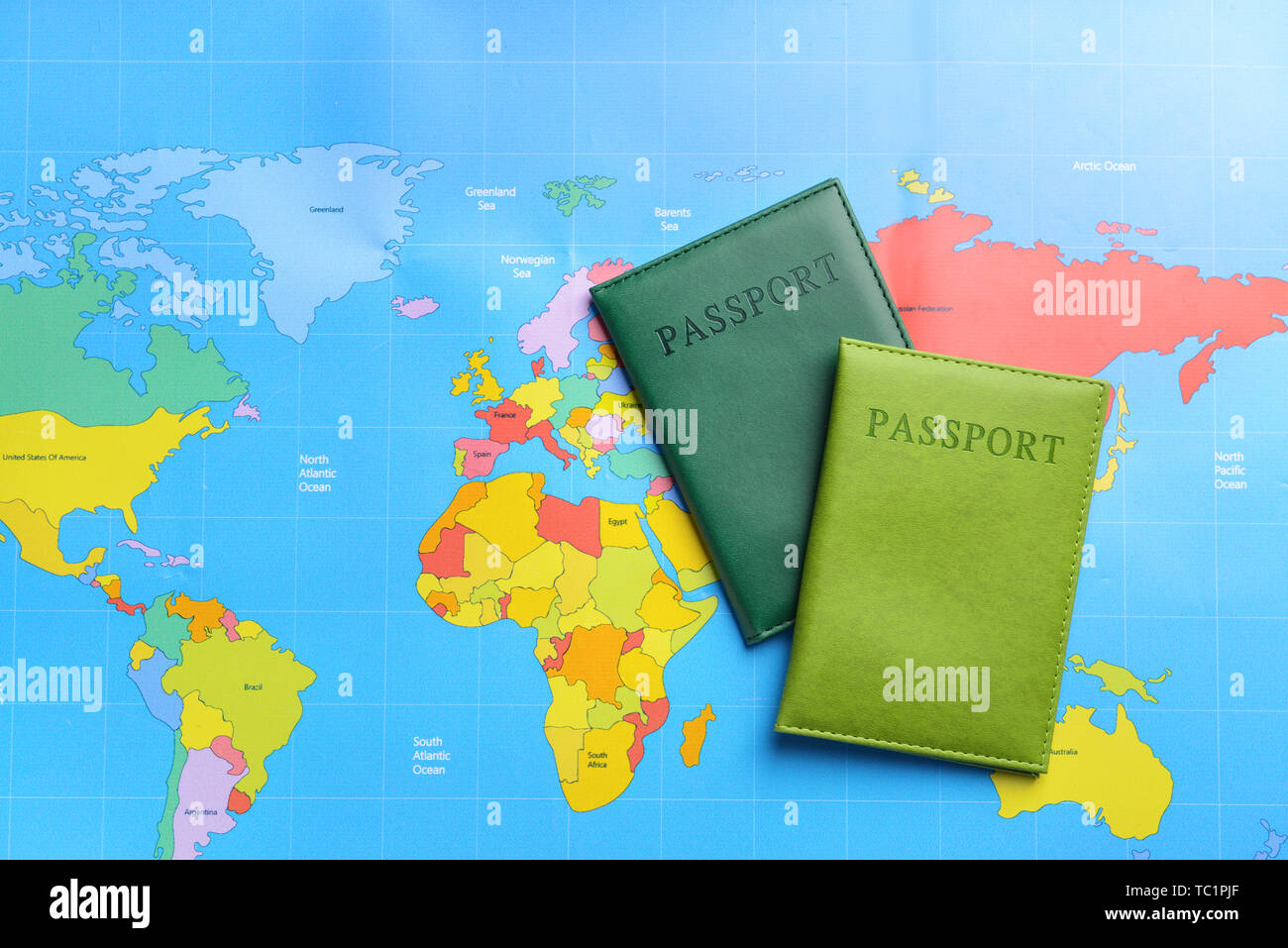 Two passports on world map. Concept of immigration Stock Photo - Alamy