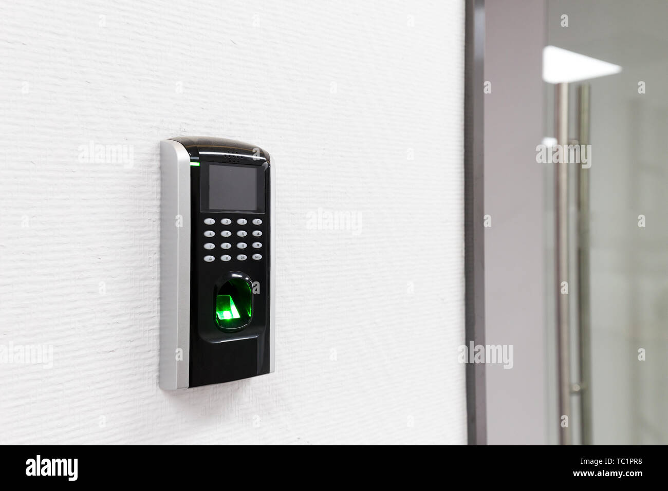 Fingerprint scanner on wall Stock Photo - Alamy