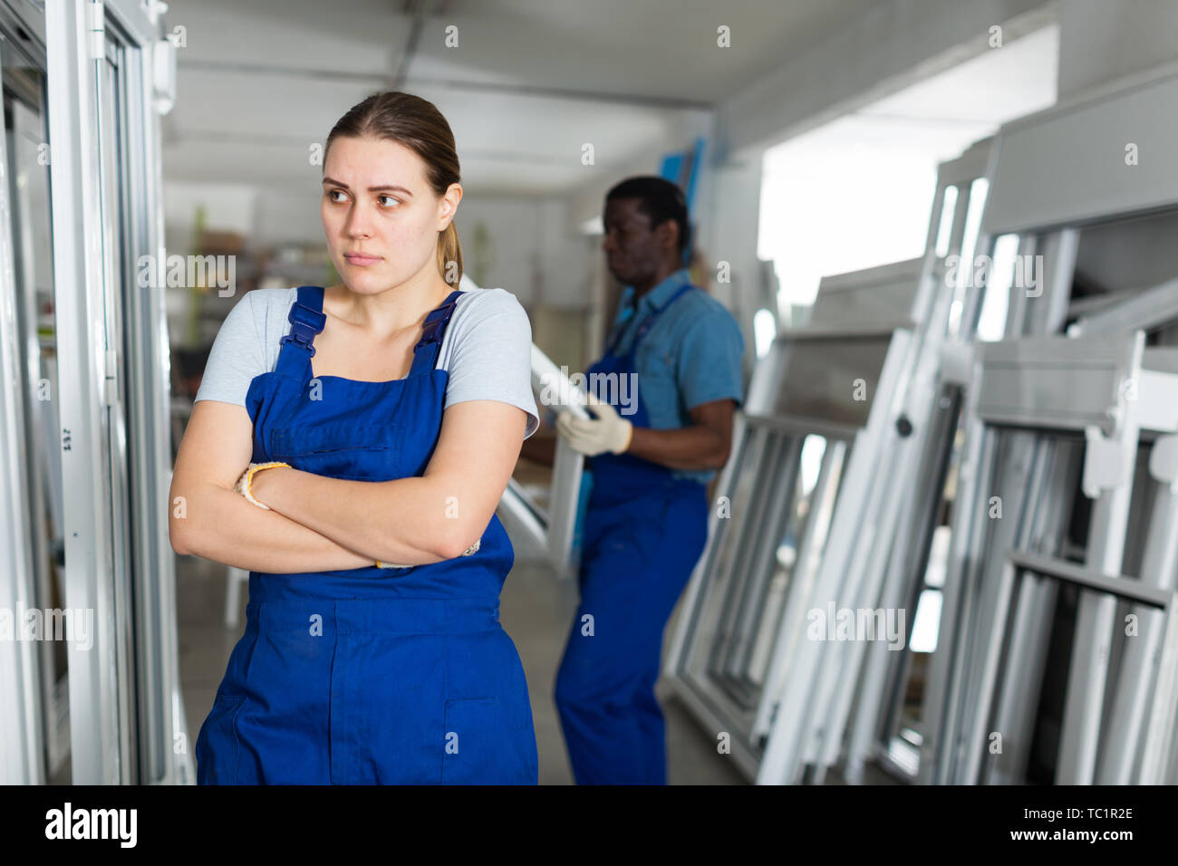 Portrait of female master who is upset in time working on her workplace ...