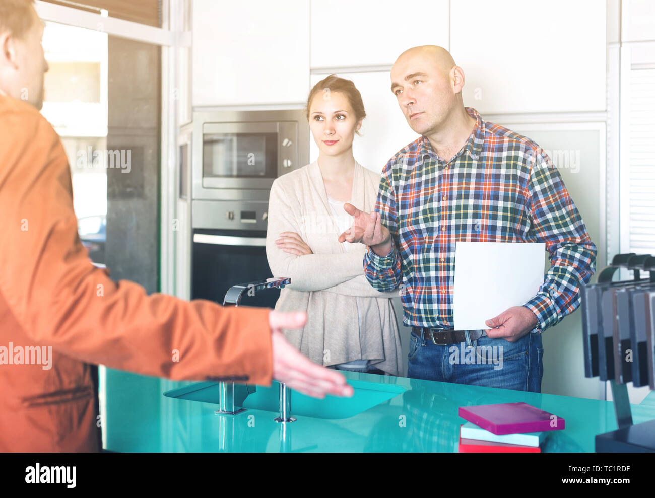 angry american couple makes claims at kitchen furniture workshop Stock ...