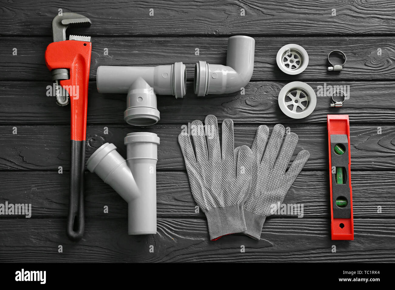Set of plumber tools on wooden background Stock Photo - Alamy