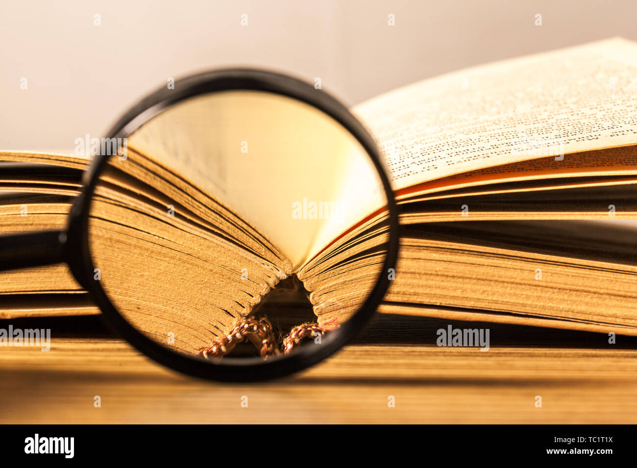 books and magnifying glass Stock Photo - Alamy
