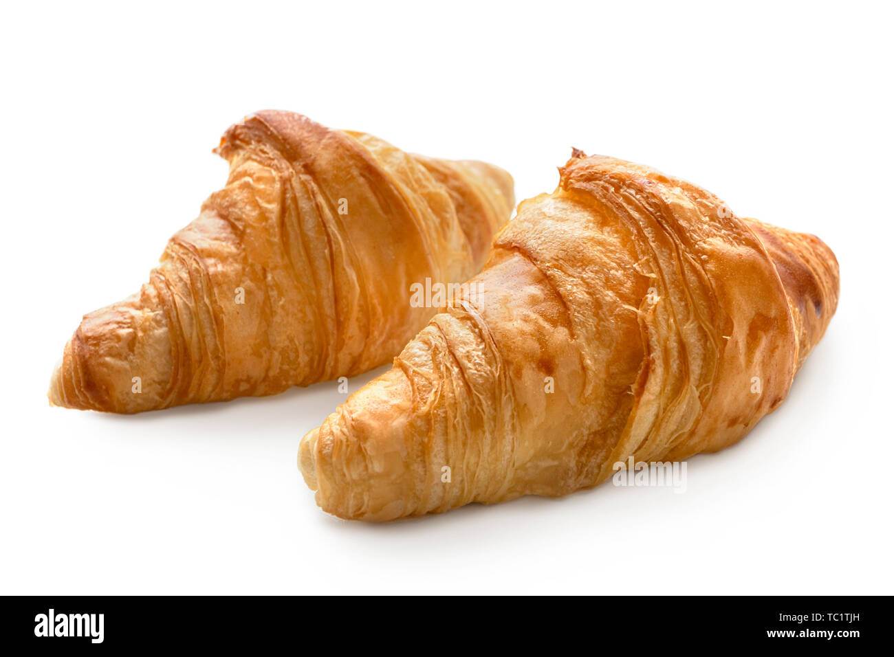 Two baked plain croissants isolated on white Stock Photo - Alamy