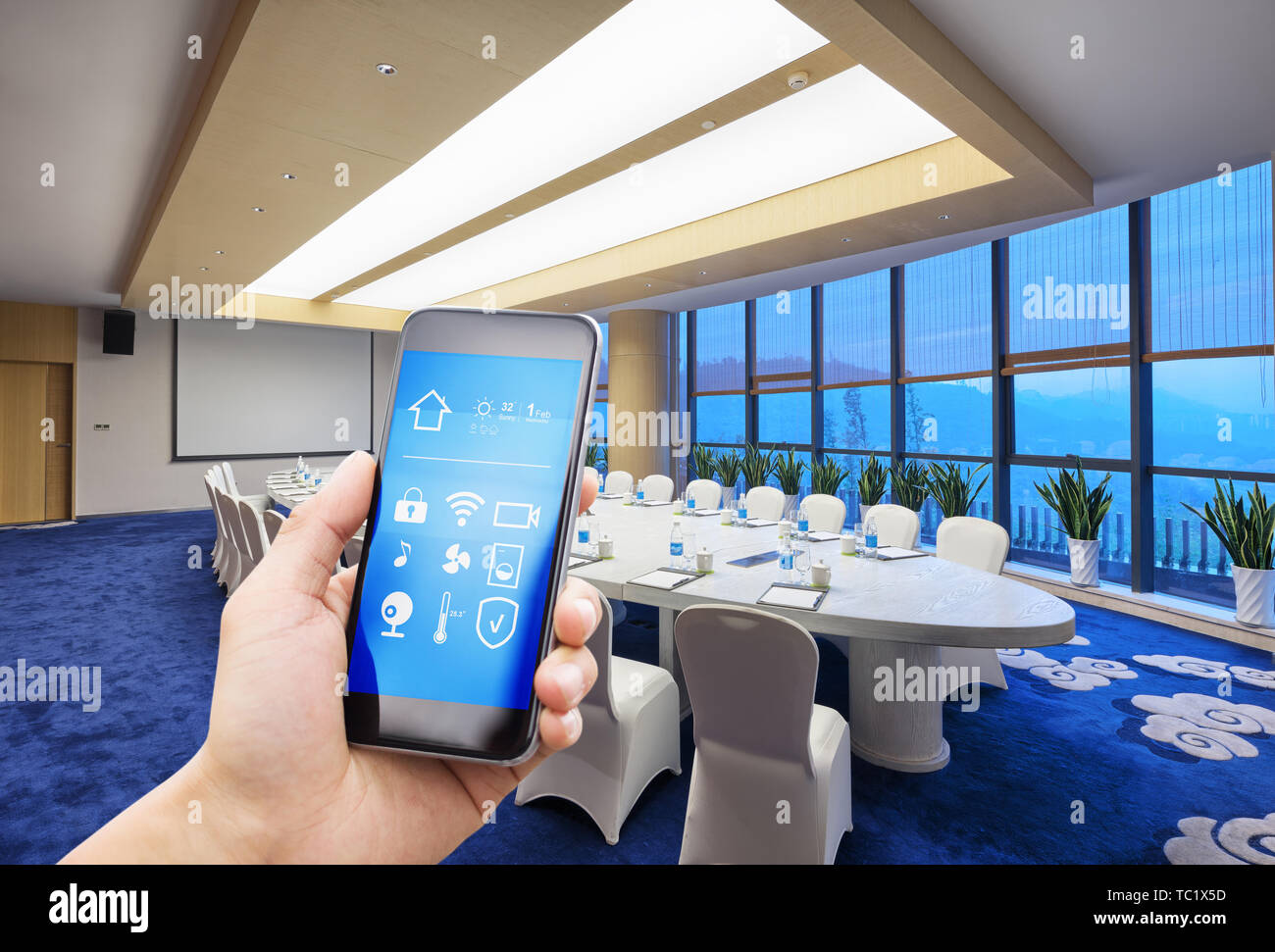 smart phone with smart home with modern meeting room Stock Photo - Alamy