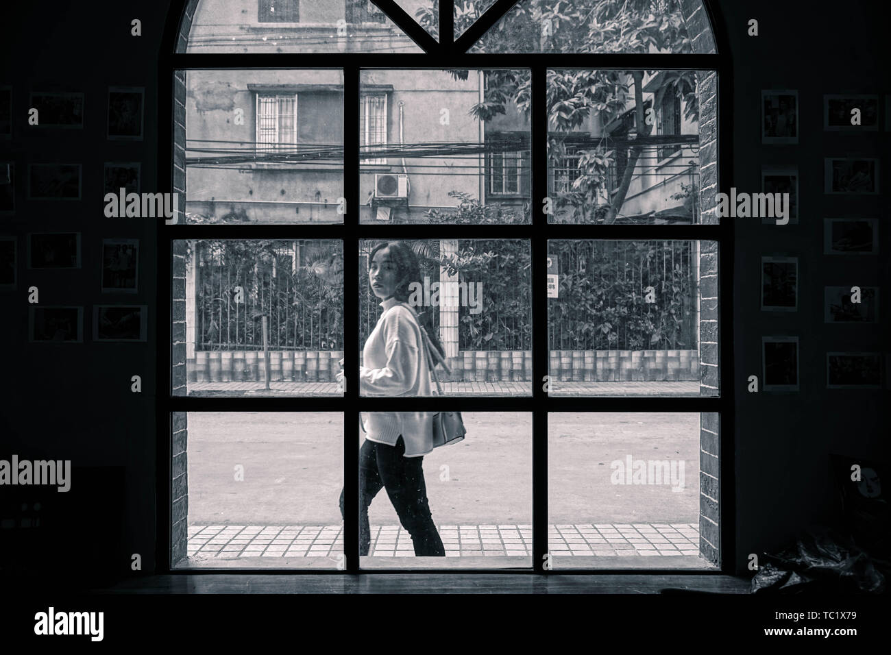 Photographer in the window, passer-by outside the window Stock Photo ...