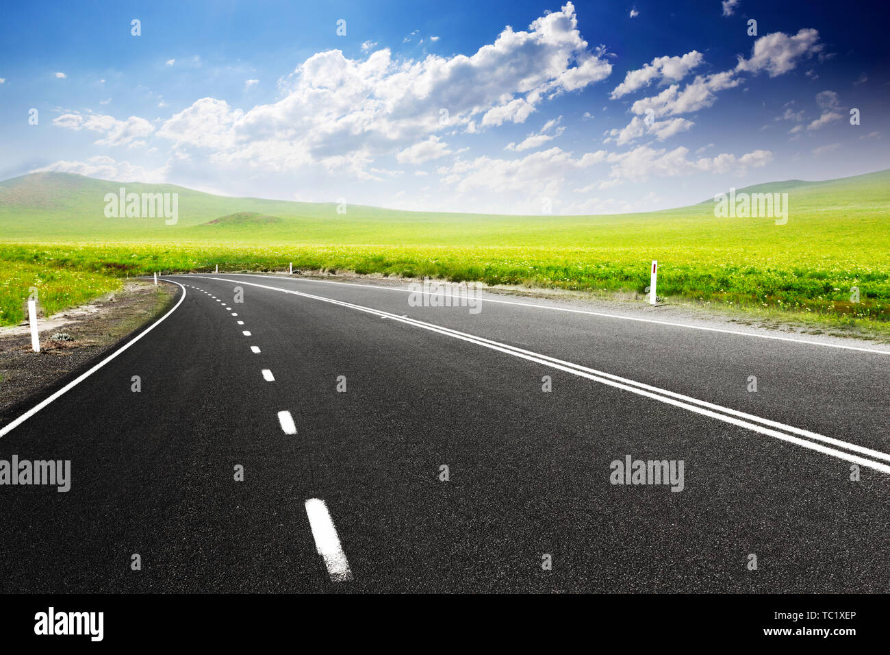 Road through meadow with cloud and sky background Stock Photo - Alamy