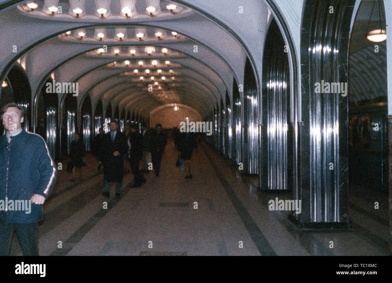 Commuters walking through a vaulted hallway inside a Moscow Metro ...