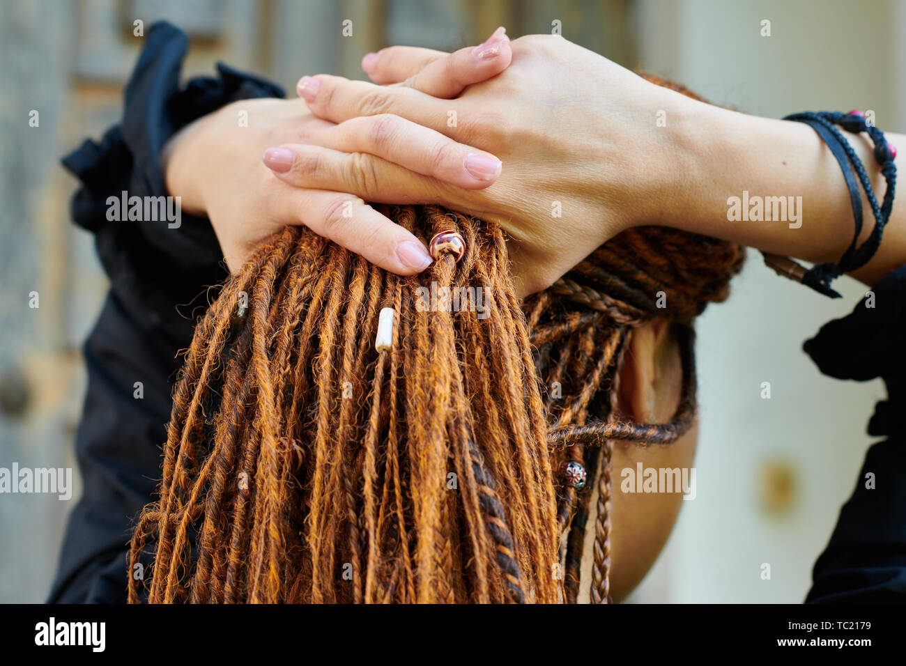 backside dreadlocks head closeup, fashionable girl posing at old wooden ...