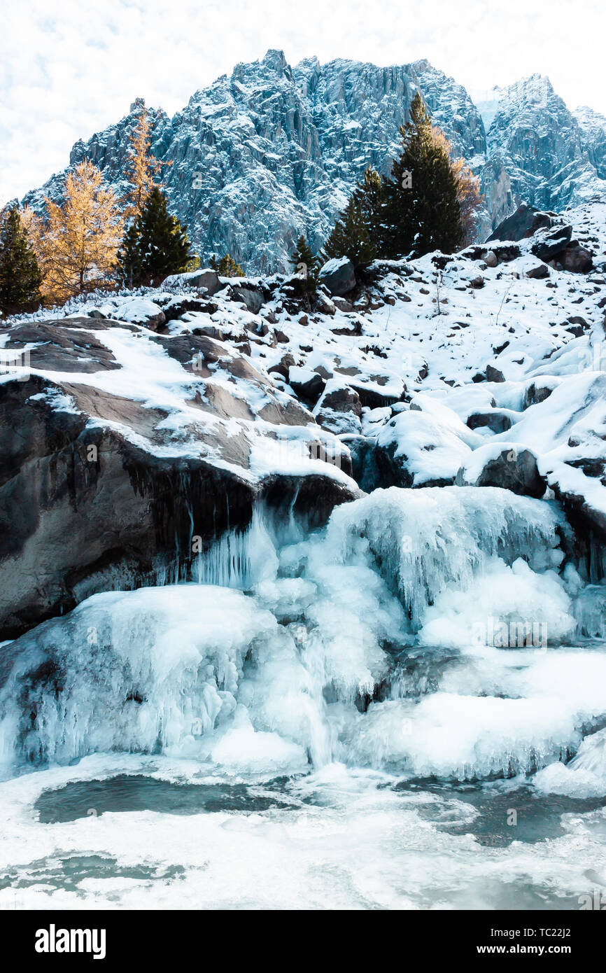 Mountain river with frozen water. Icicles by the river, cooling in ...