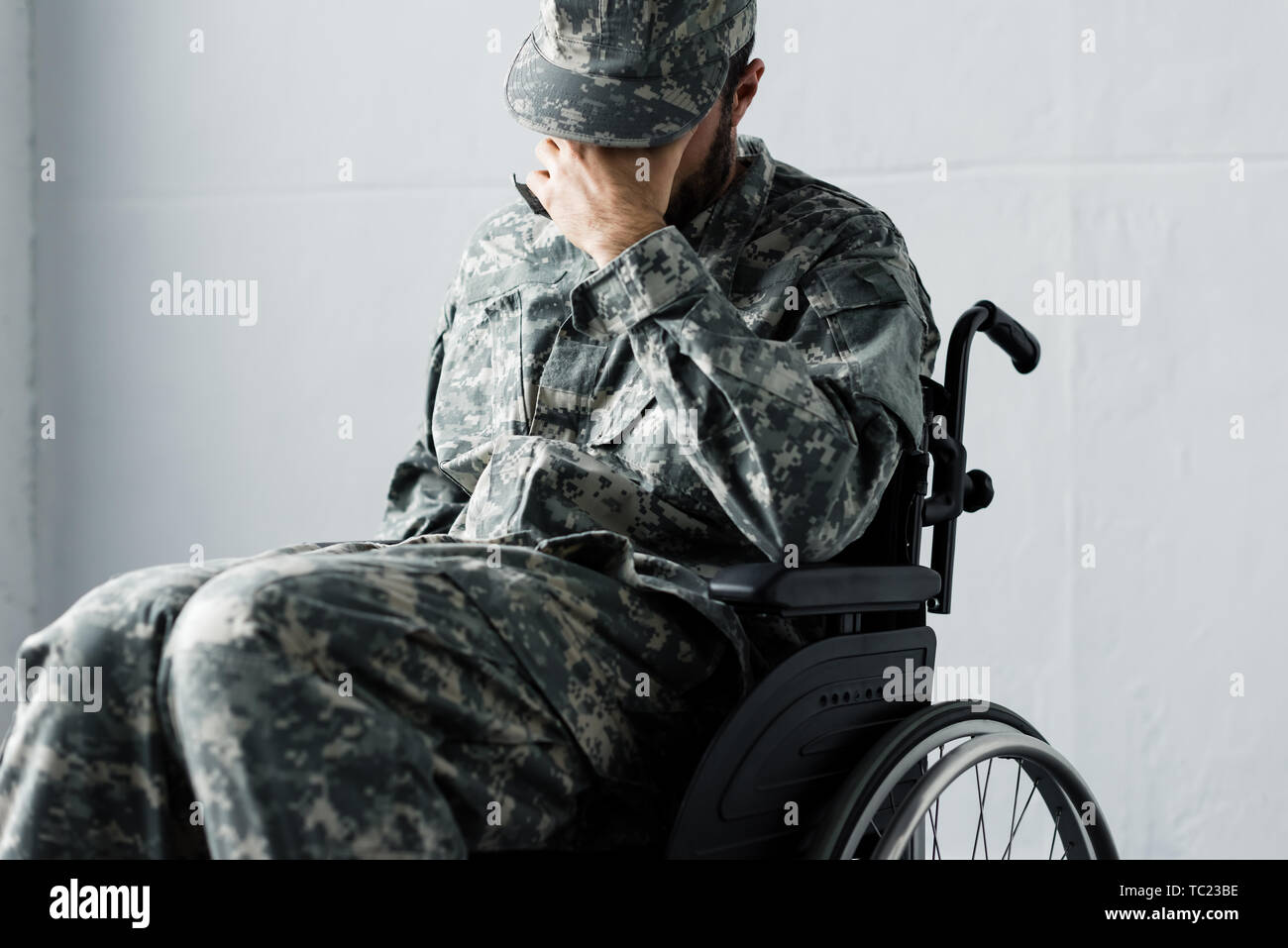 depressed disabled military man in uniform sitting in wheelchair and ...