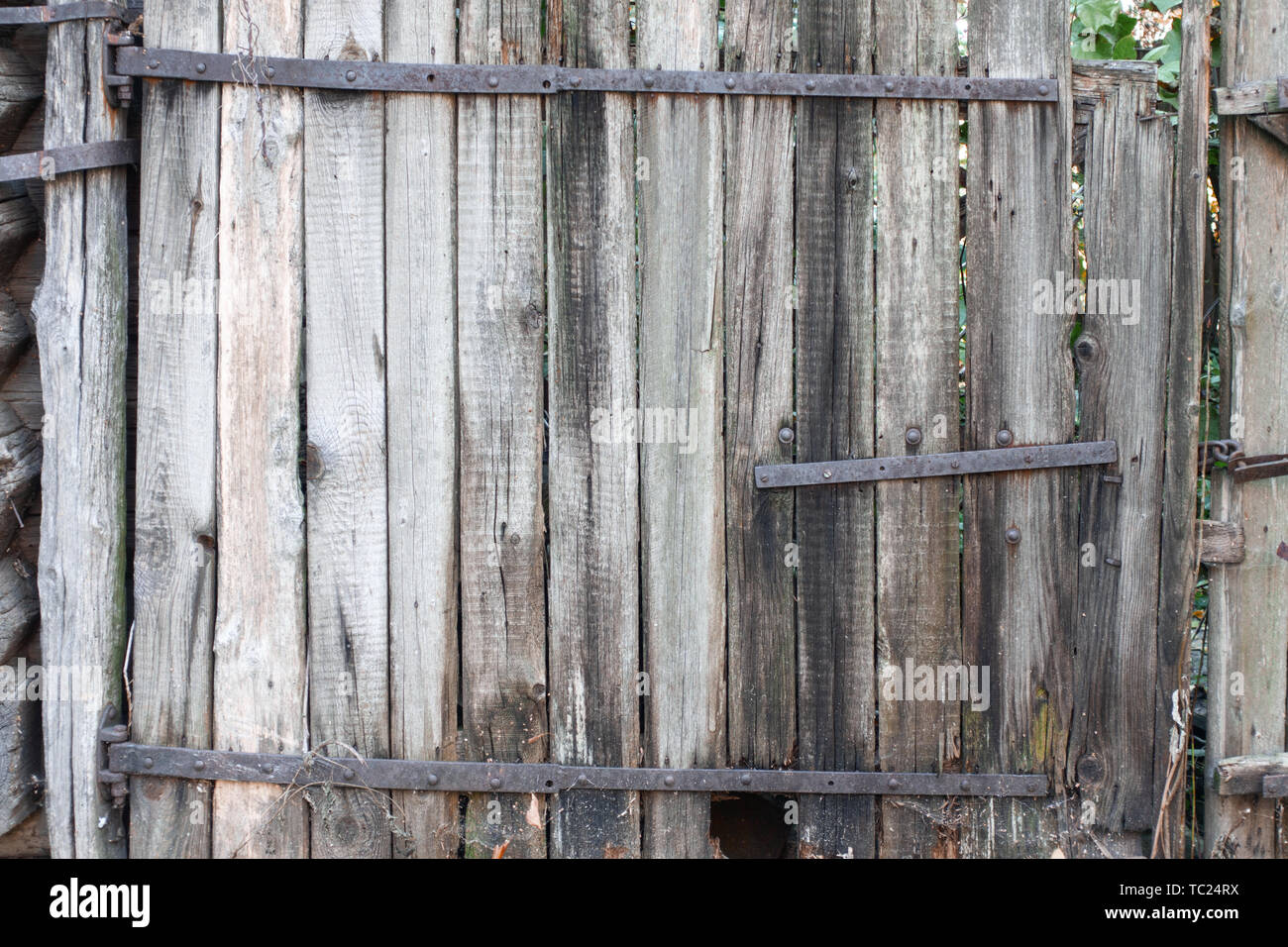 Old wooden fence with rusty metal plates. background. texture Stock ...