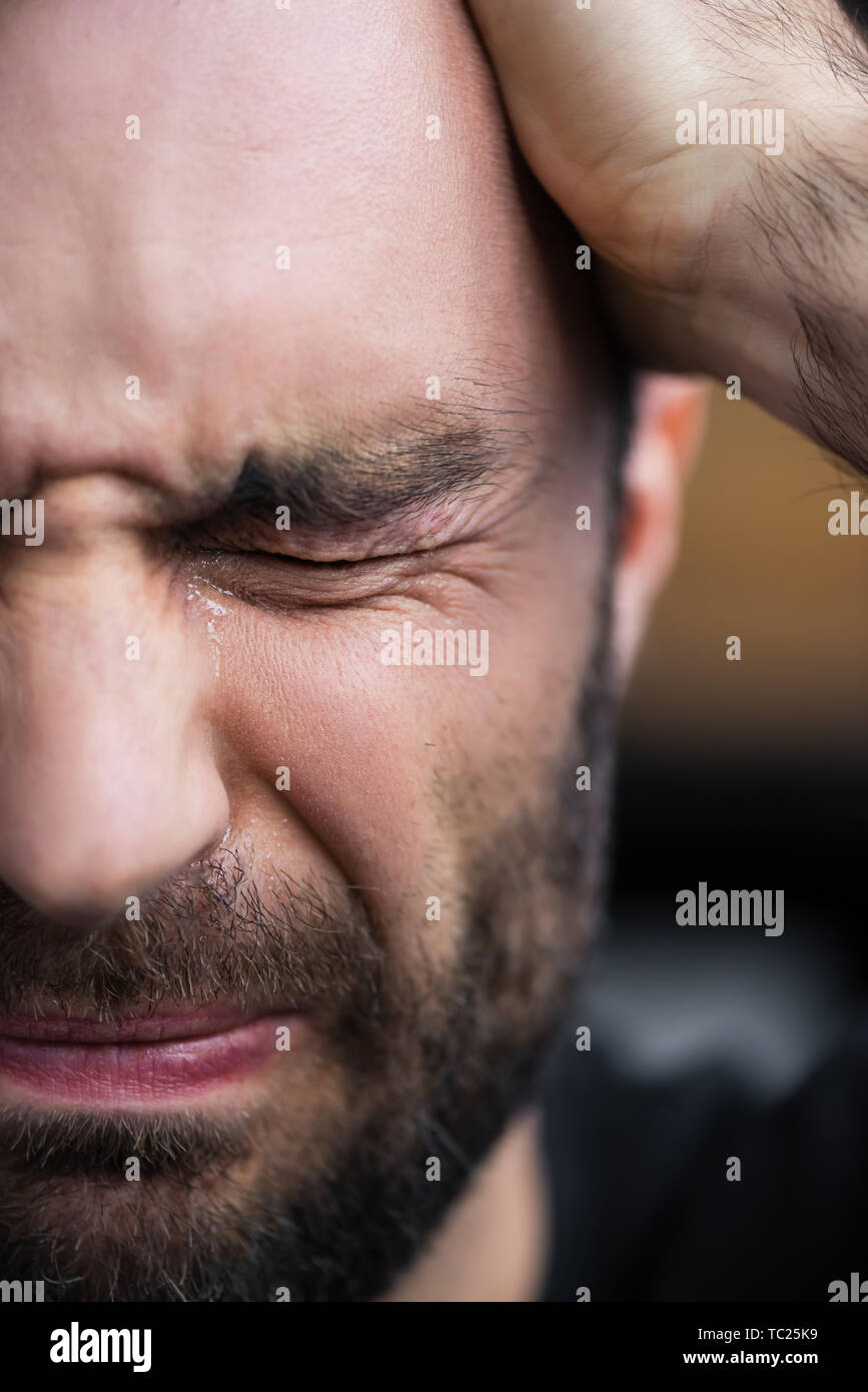 partial view of depressed bearded man crying with closed eyes Stock ...