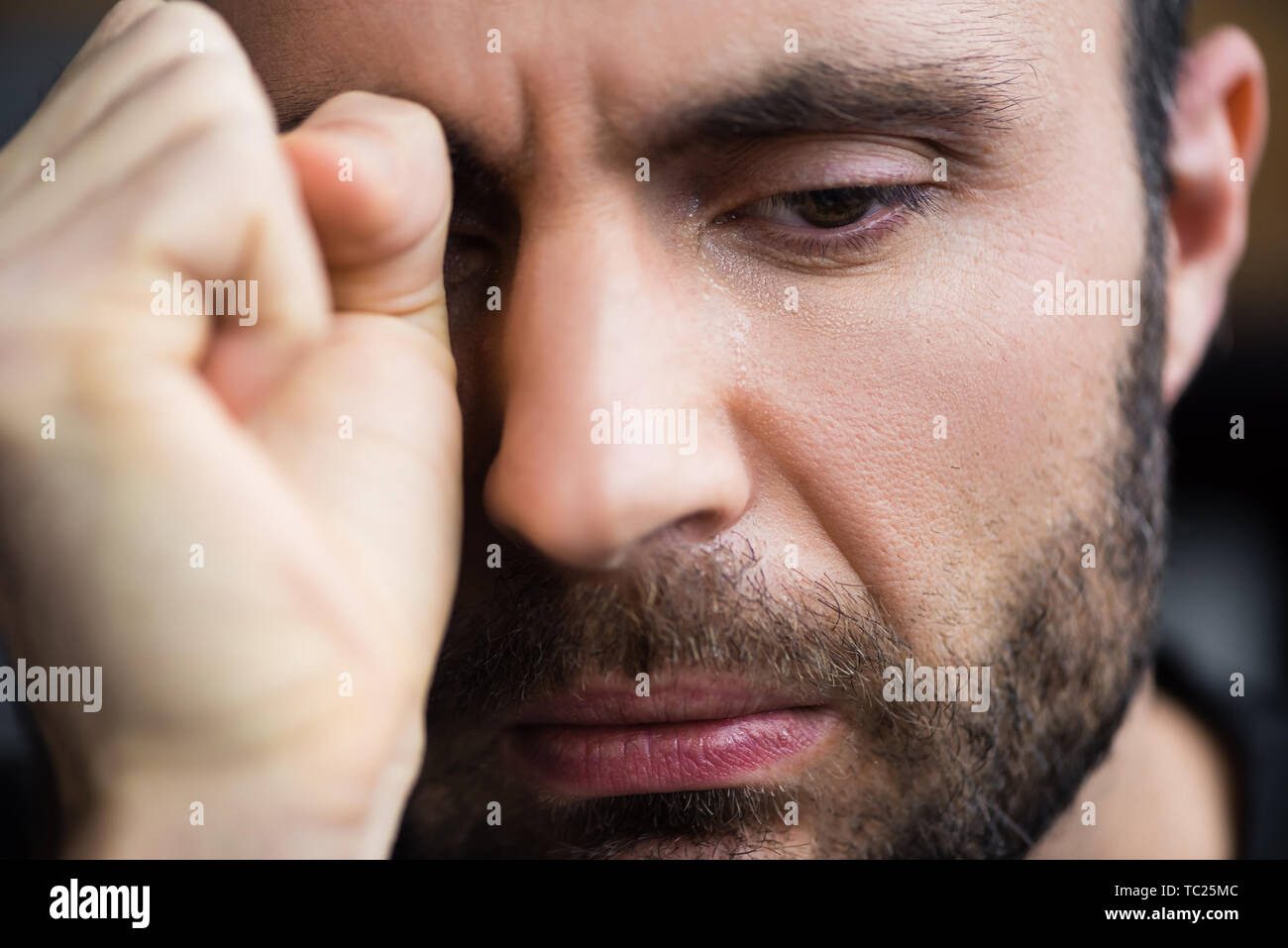 portrait of handsome crying man wiping tears away with hand Stock Photo ...