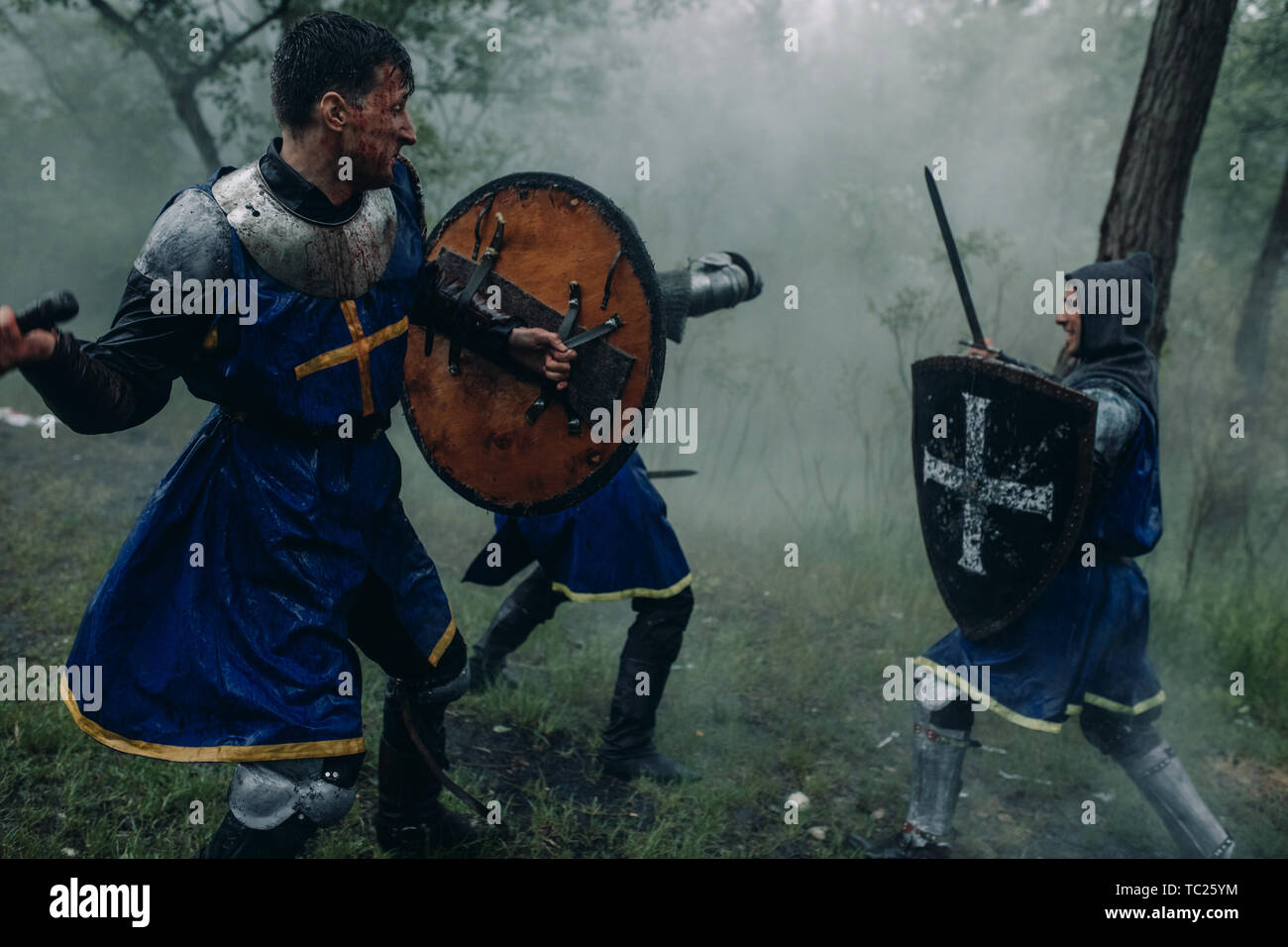 Threee young men in the image of a medieval knights crusaders in armor ...