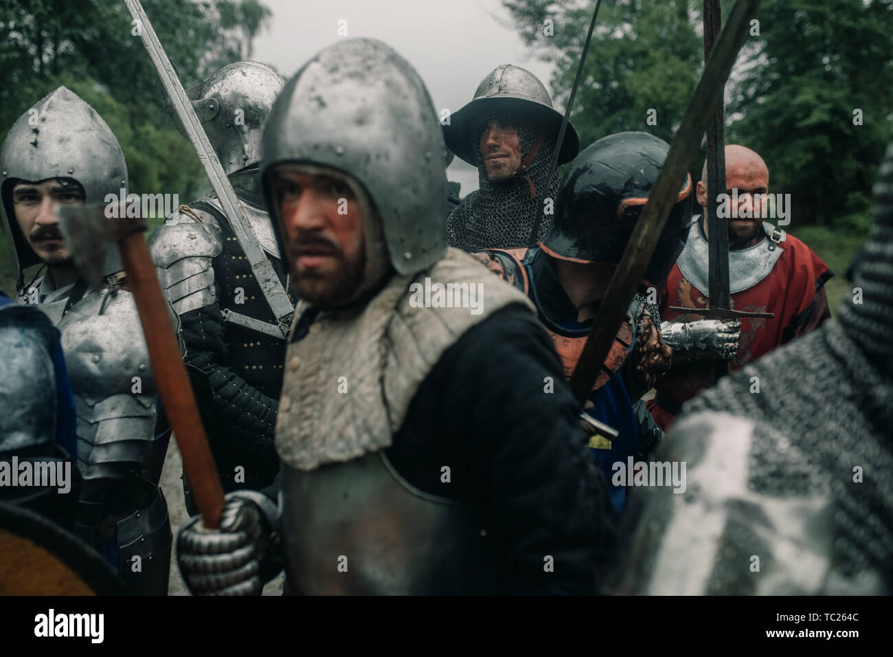 Battle squad of medieval knights of the Crusaders stand in armors and ...
