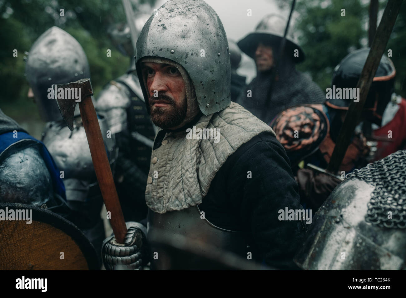 Battle squad of medieval knights of the Crusaders stand in armors and ...