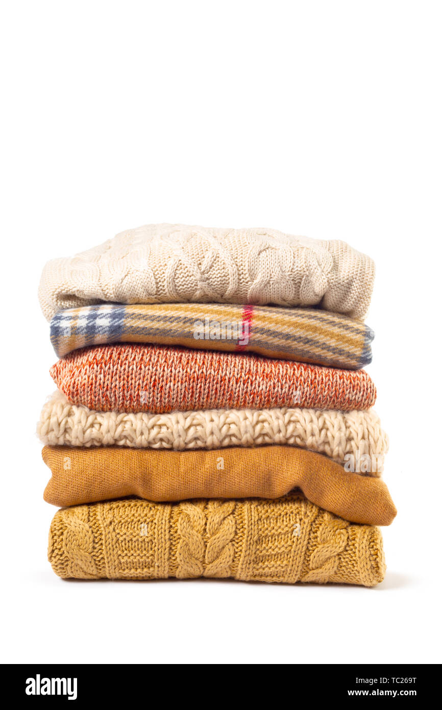 Stack of various sweaters isolated on white background Stock Photo - Alamy