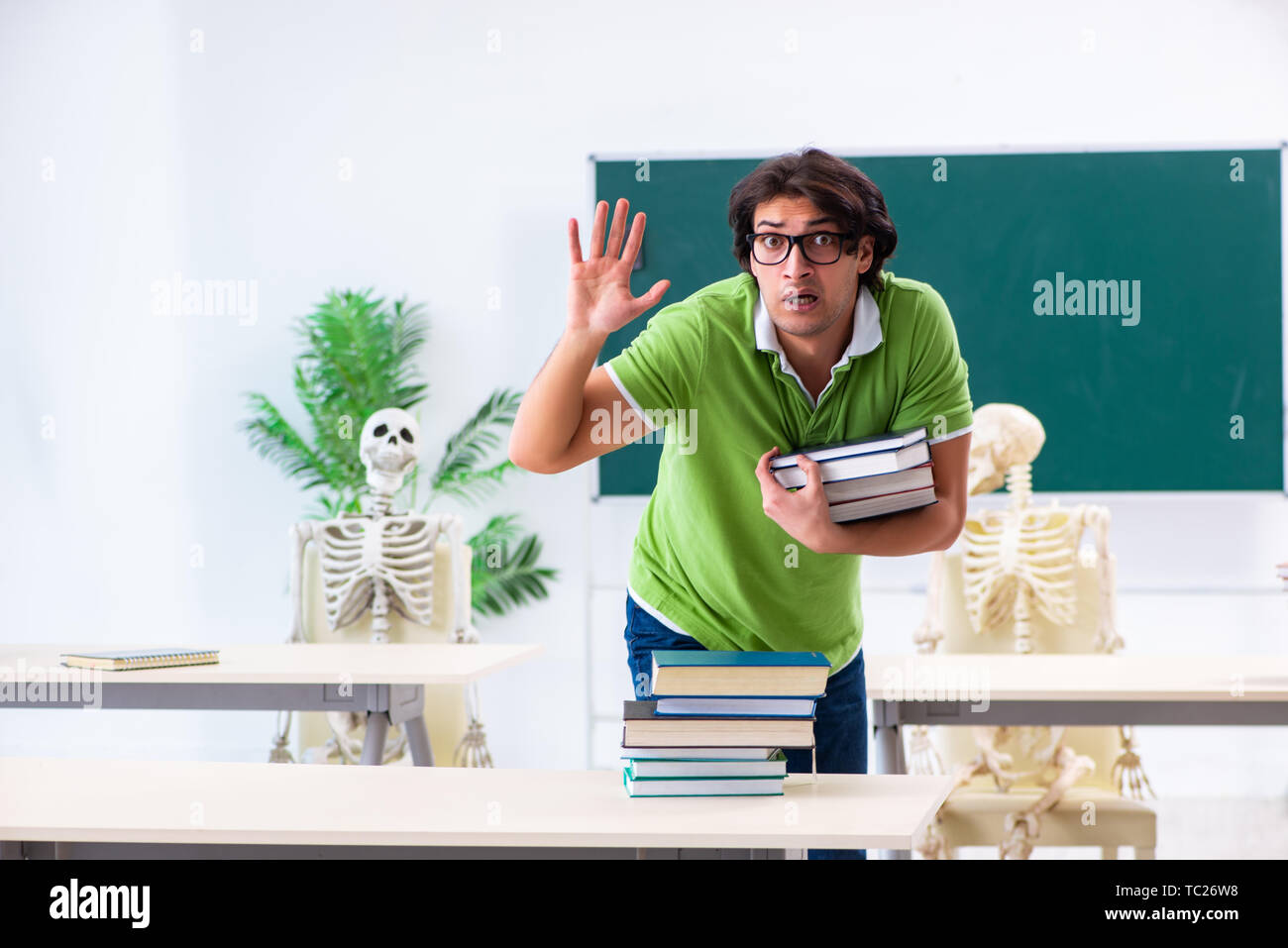 Funny male student in the classroom with skeleton Stock Photo - Alamy
