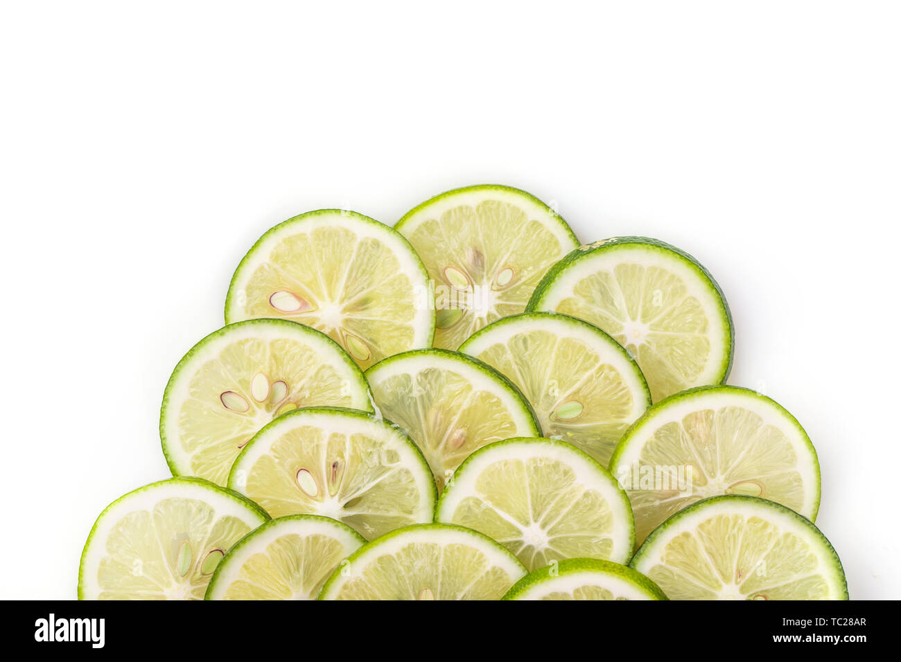 Green lemon slices on white background Stock Photo - Alamy