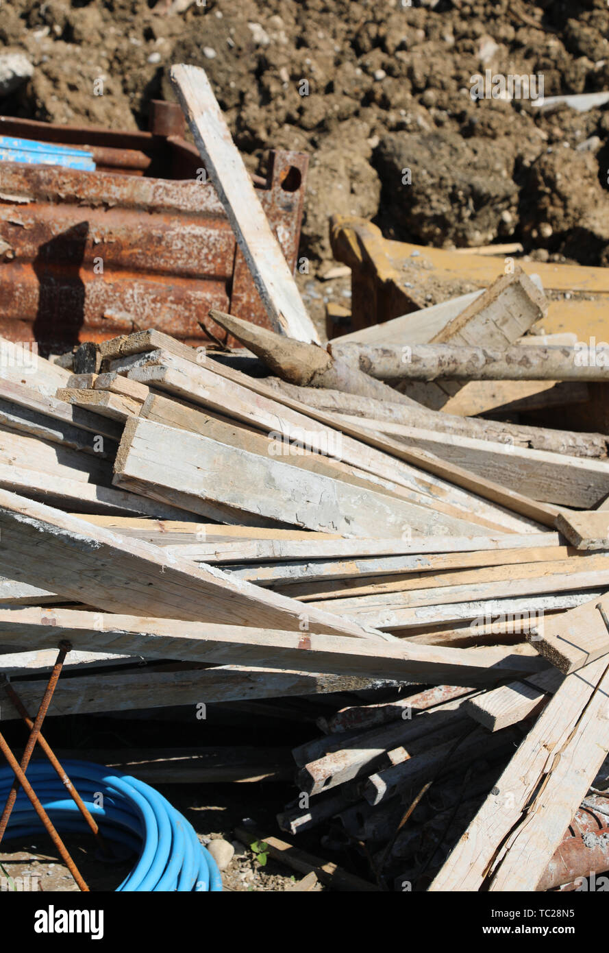 many wooden boards and building material on the construction site ...