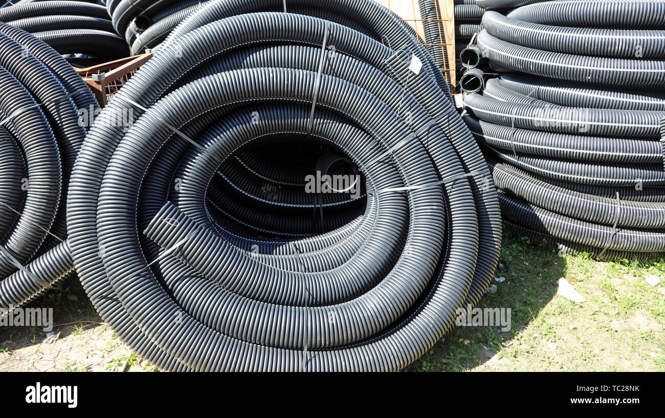 storage on the construction site with many rolls of corrugated tubes ...