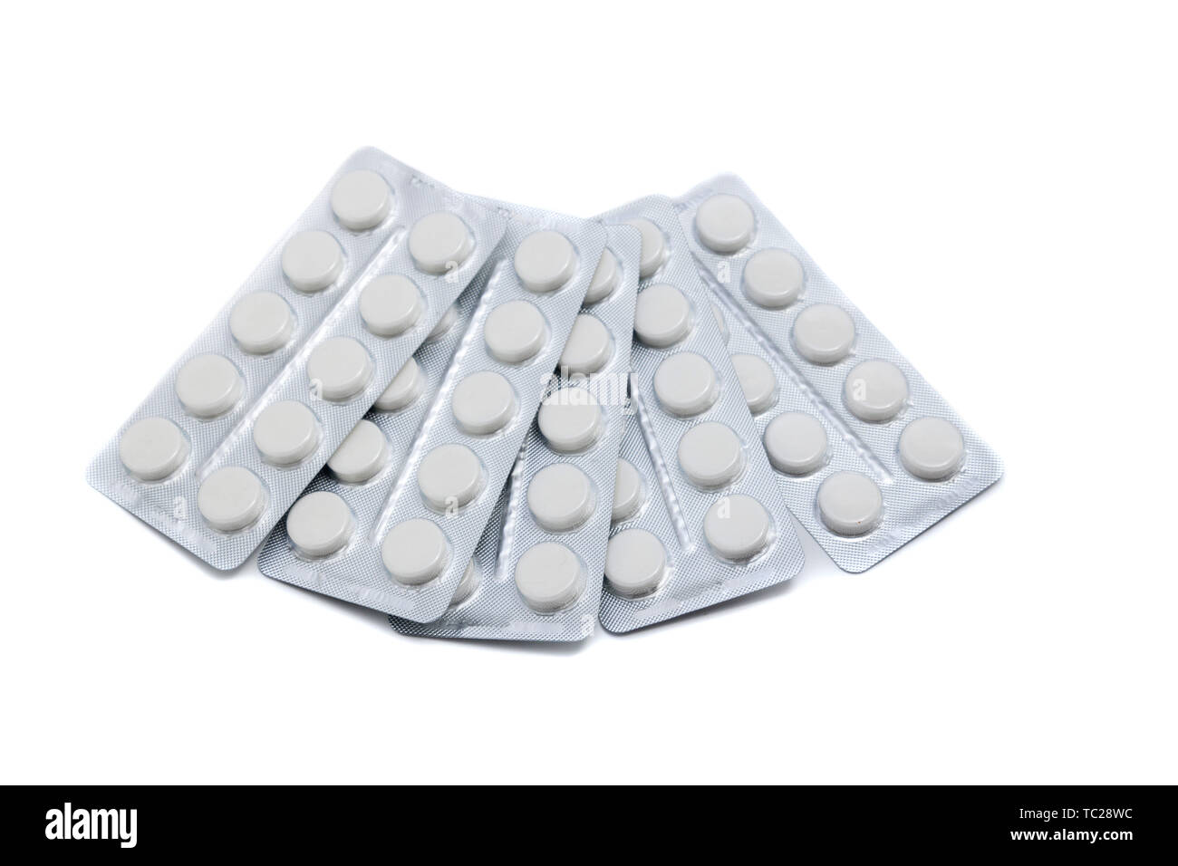 white pills in packaging sheets on white background Stock Photo - Alamy
